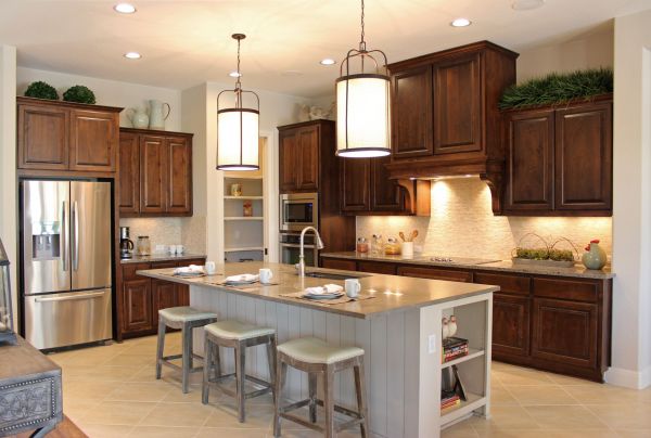 Burrows Cabinets' kitchen in knotty alder w custom vent hood