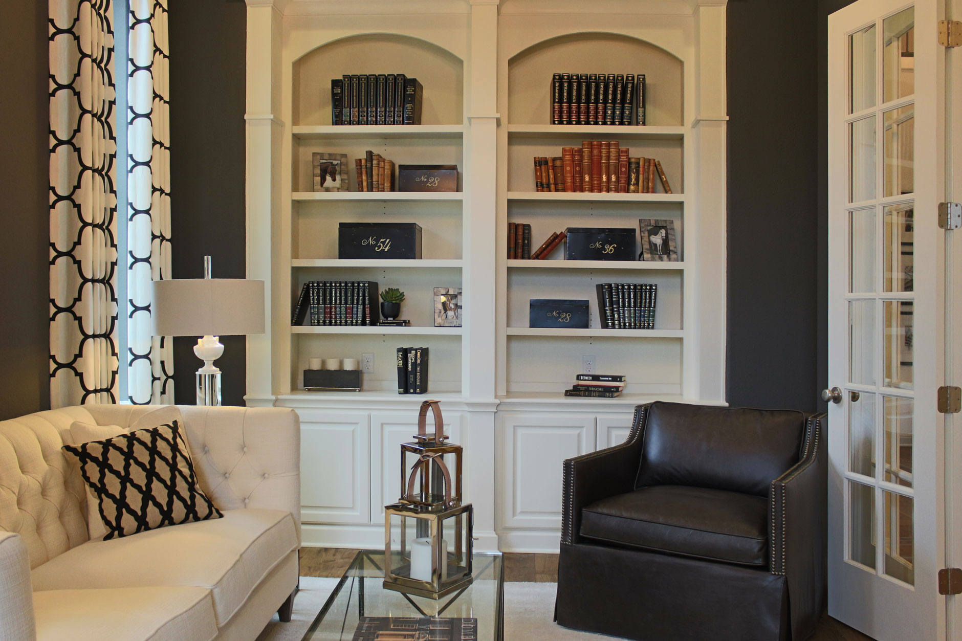 study with built in open bookshelves and white cbase cabinets